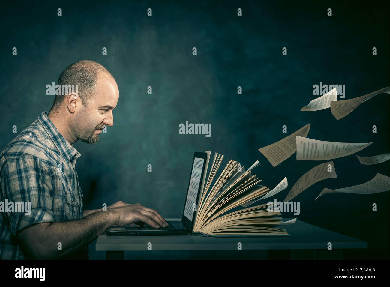 PC writer and book that is created and sheets that fly away Stock Photo ...