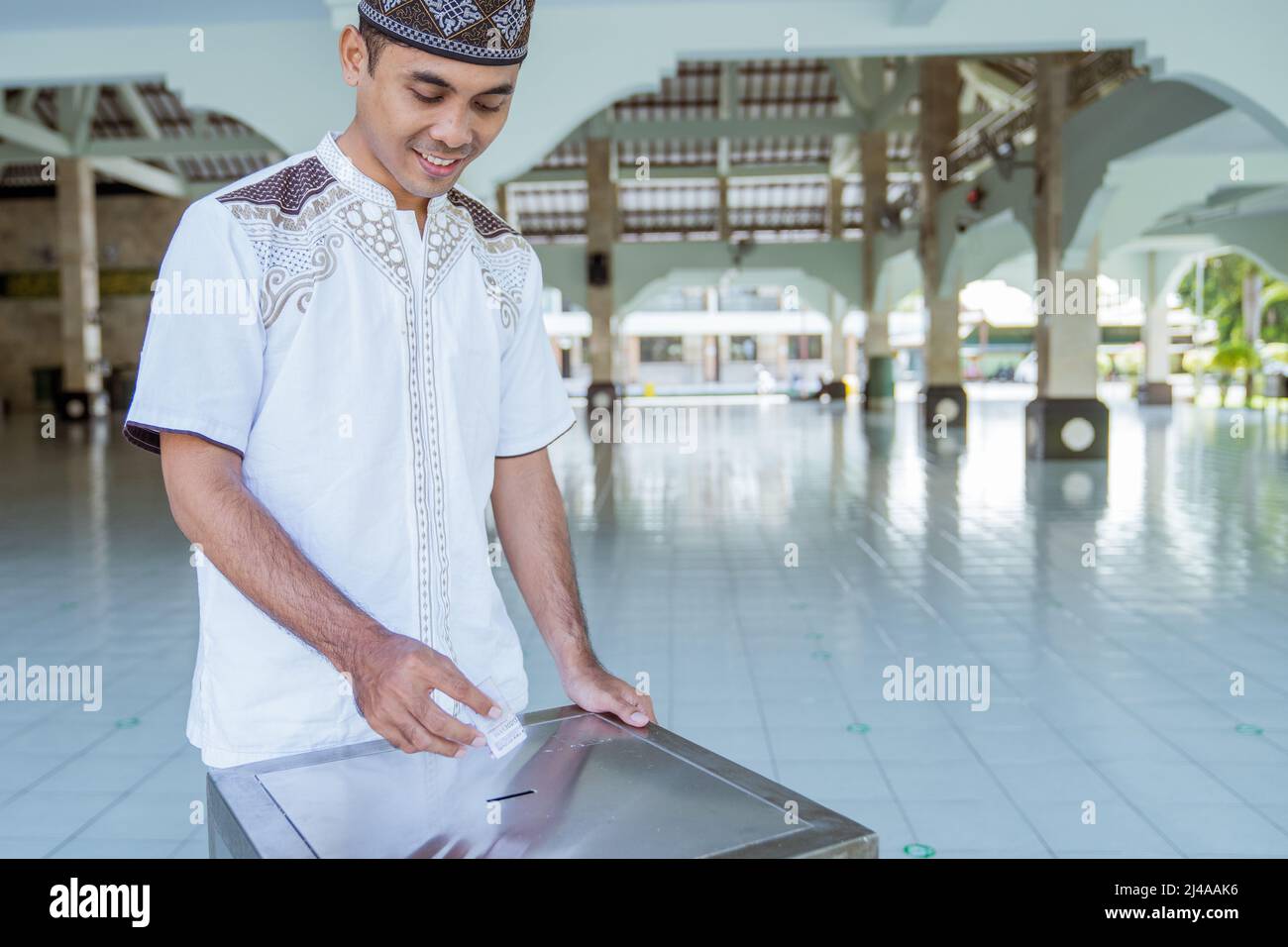 muslim paying some zakat charity using cash at the mosque Stock Photo ...
