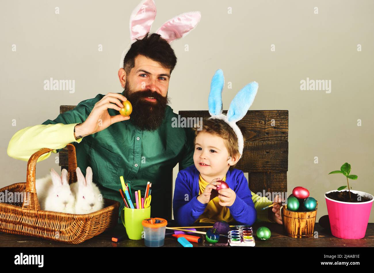 Happy easter celebration. Father and son with painted colorful eggs ...