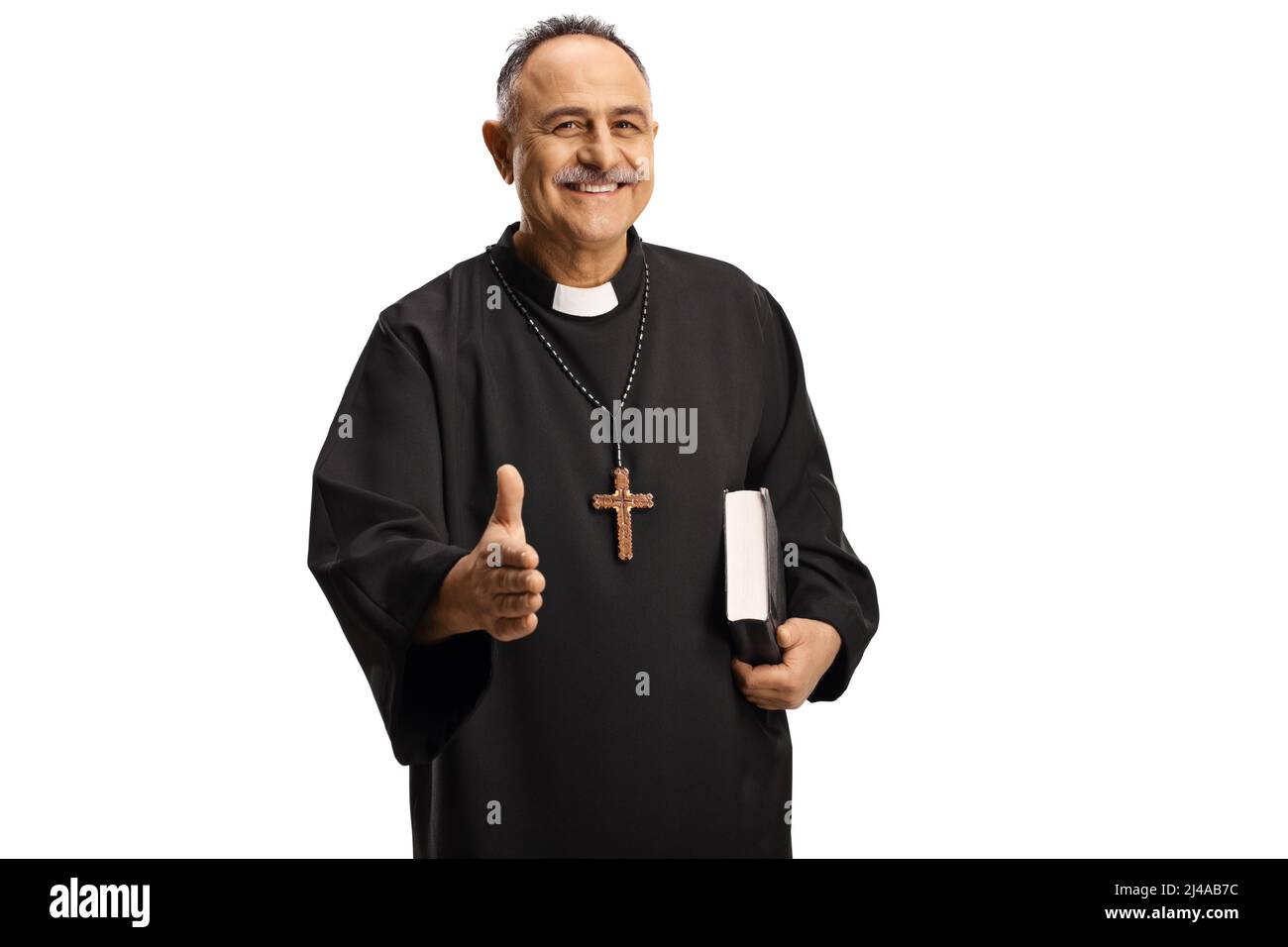 Happy priest gesturing handshake and holding a bible isolated on white ...