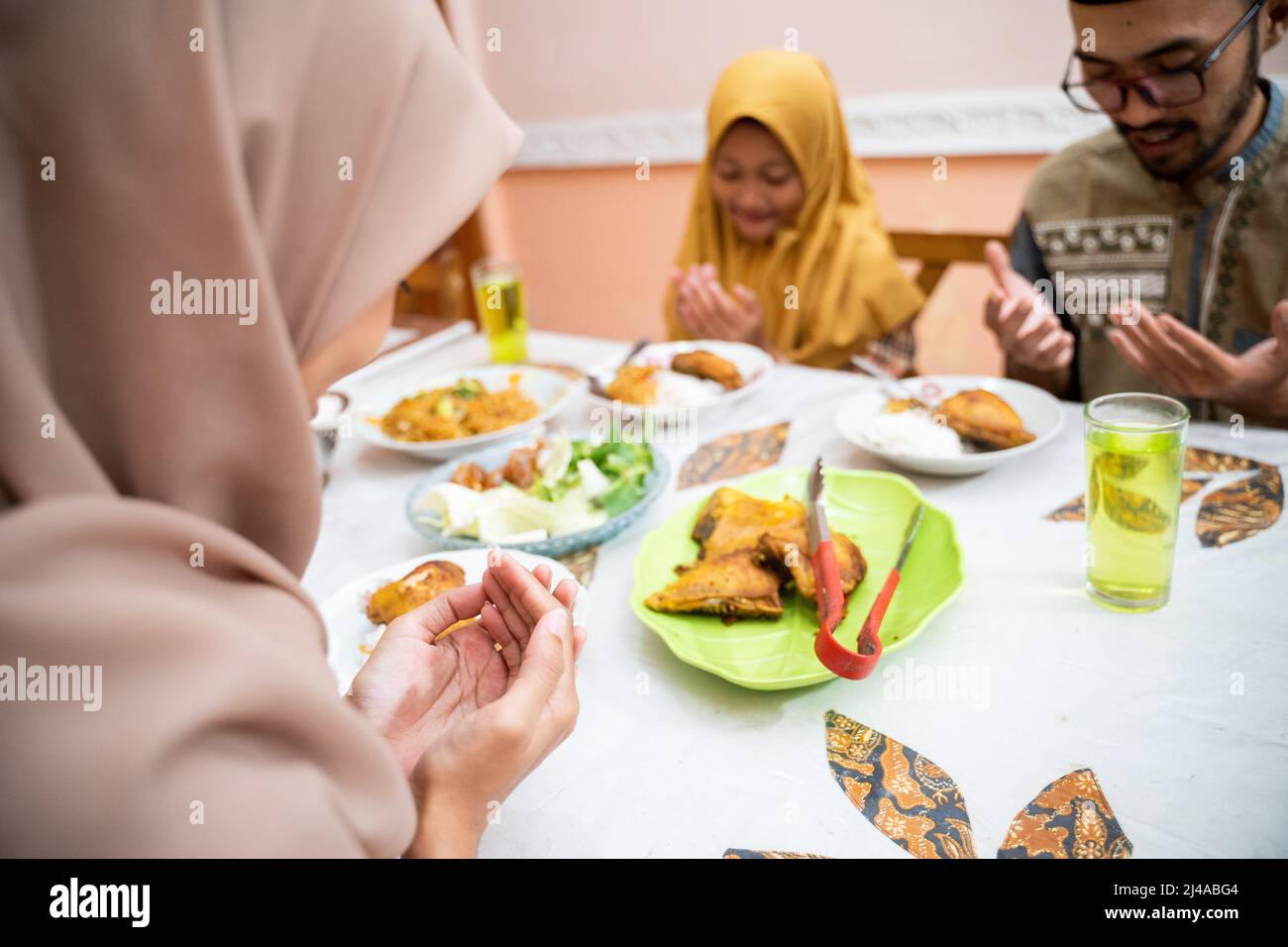 muslim mother serving some food for family dinner Stock Photo - Alamy