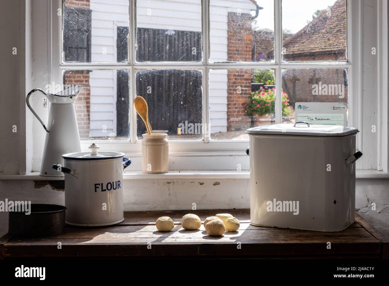 A rustic kitchen scene with a flour can and flour balls on an old ...