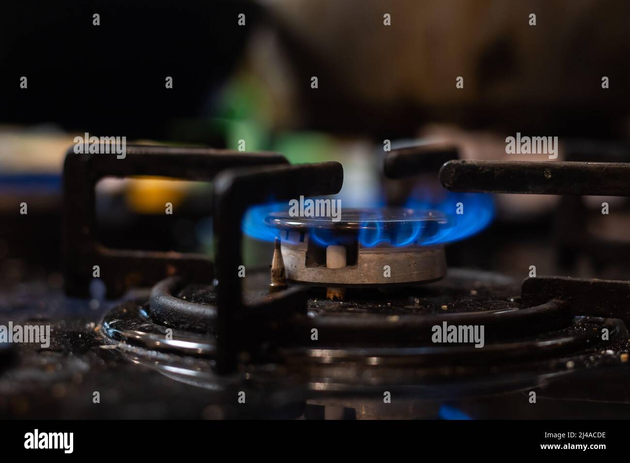 Closeup shot of blue fire from domestic kitchen stove top. Gas cooker ...