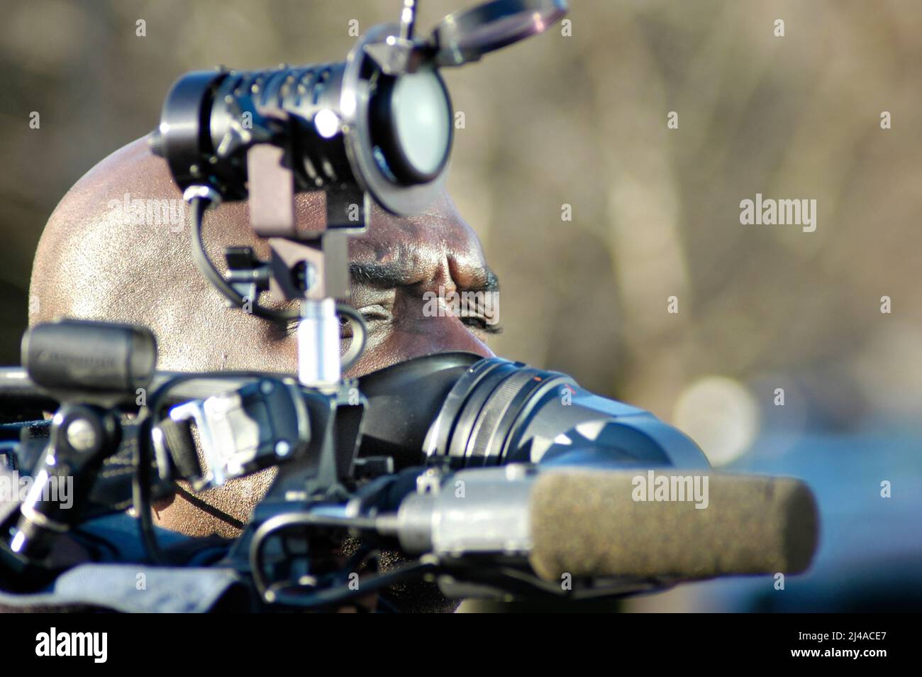 Television camerman photojournalist in the field at event recording and ...