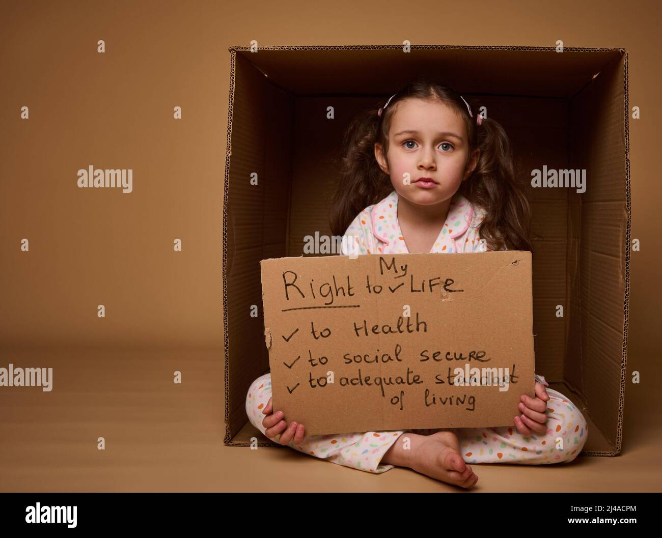 Adorable little Caucasian girl holding a cardboard poster with social ...