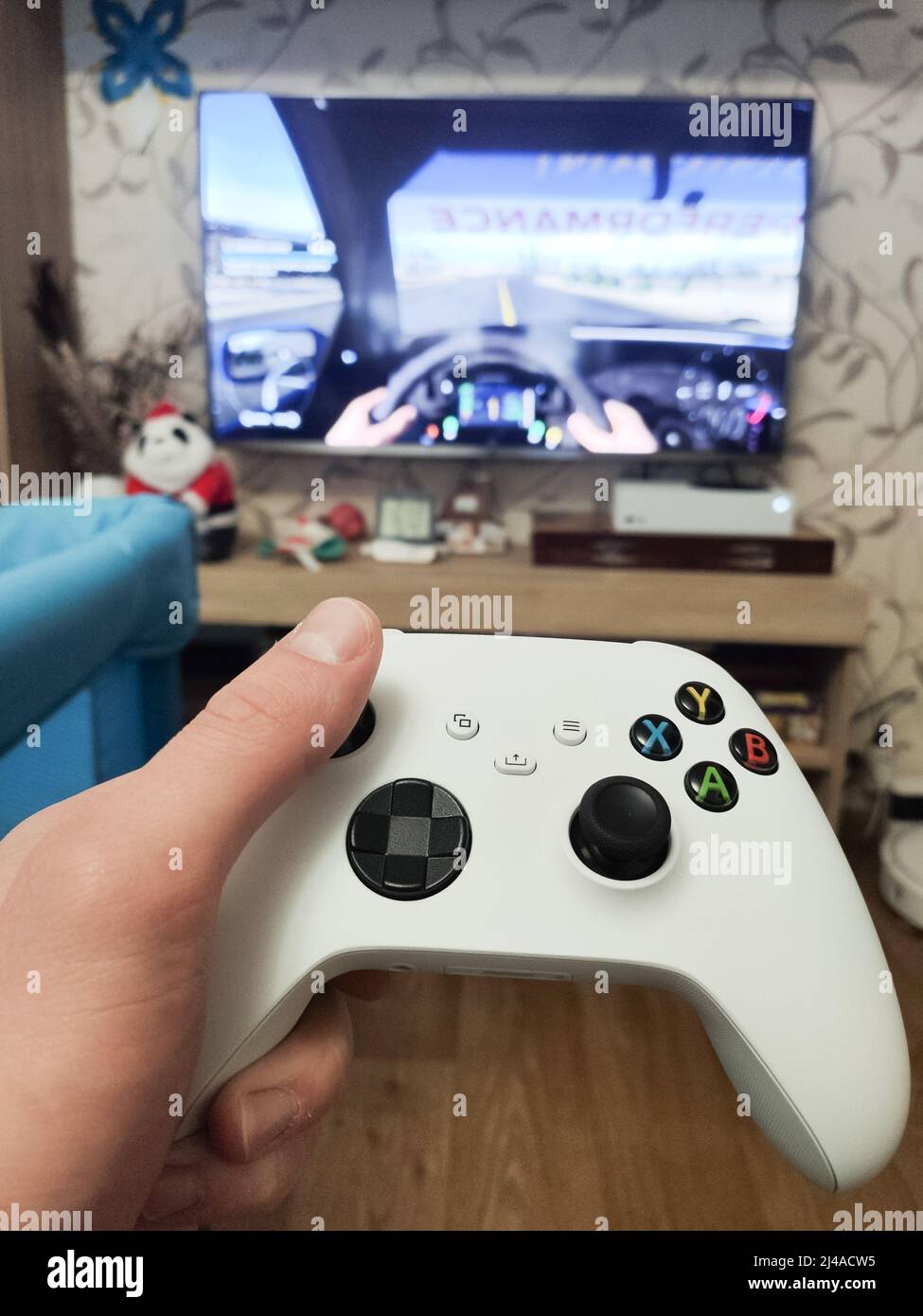 a joystick from game console with tv in room Stock Photo - Alamy