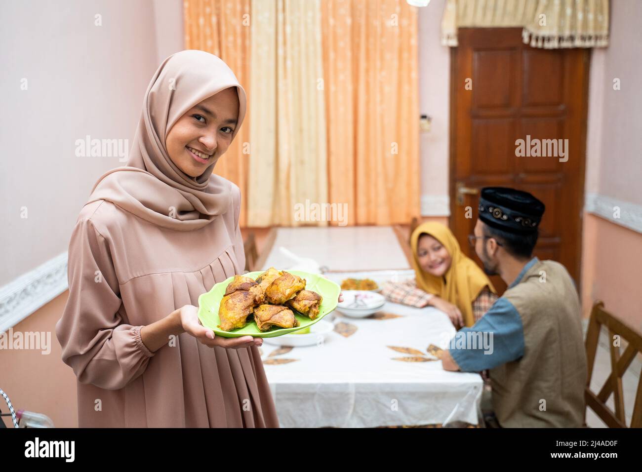 muslim mother serving some food for family dinner Stock Photo - Alamy