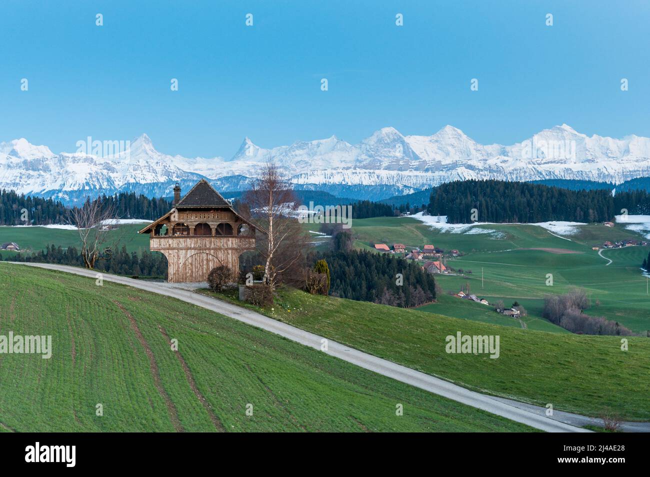 Emmental farmhouse with a view of the Bernese Alps during blue hour ...