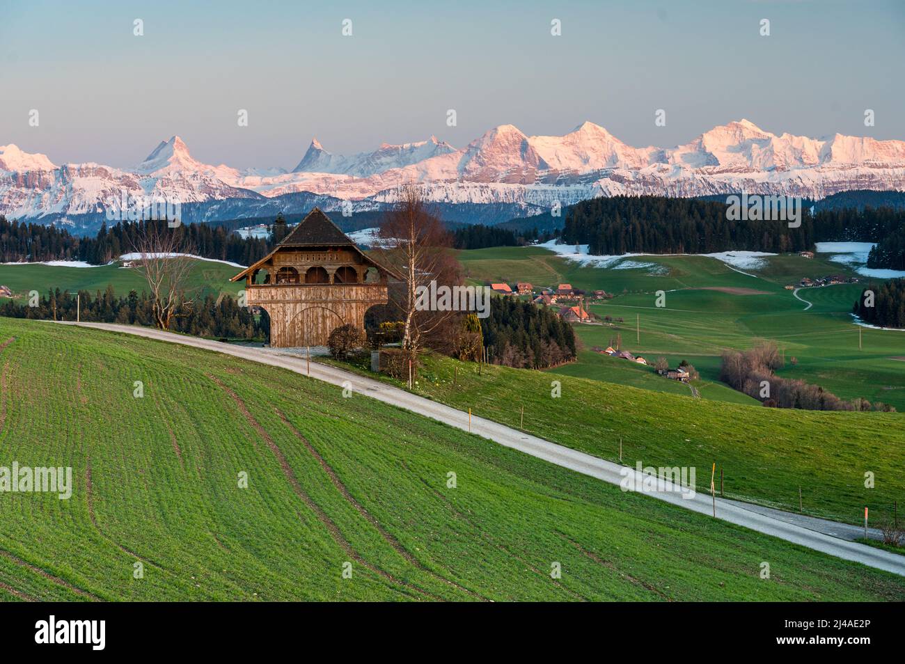 Emmental farmhouse with a view of the Bernese Alps at sunset Stock ...