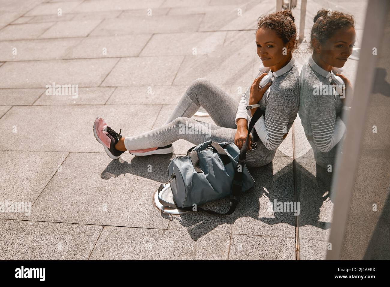 Healthy sportive woman having a break after workout in the city Stock ...