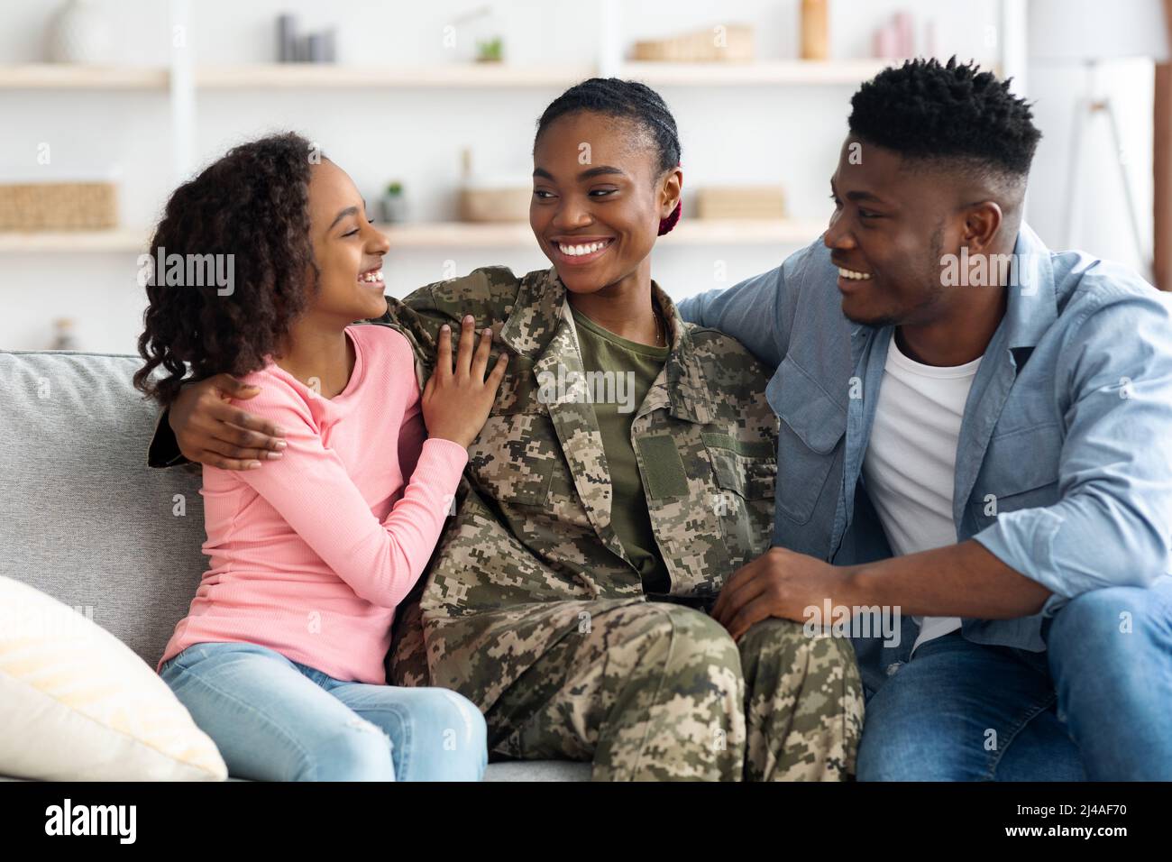 Loving african american family celebrating reunion with mother soldier ...