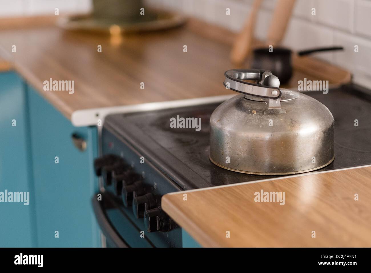 dirty metal kettle with stains on an induction hob Stock Photo - Alamy