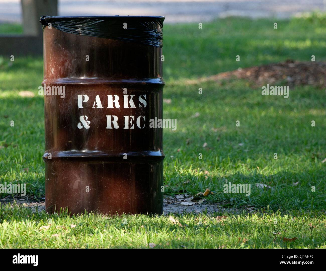 Parks and rec outdoor garbage can at a public park Stock Photo - Alamy