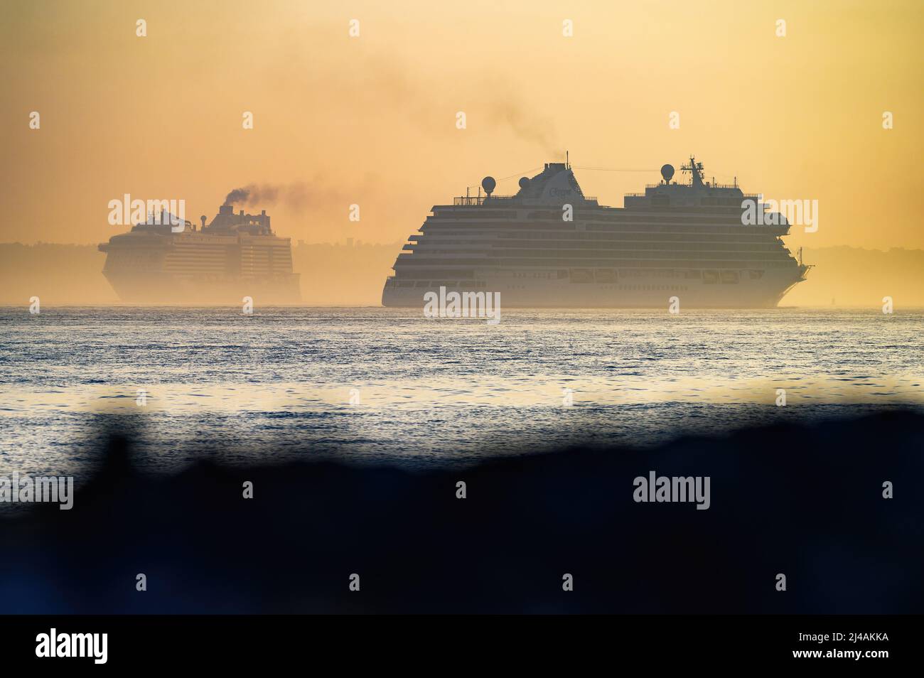 A moody, sunset view of cruise ships passing - September 2021 Stock ...