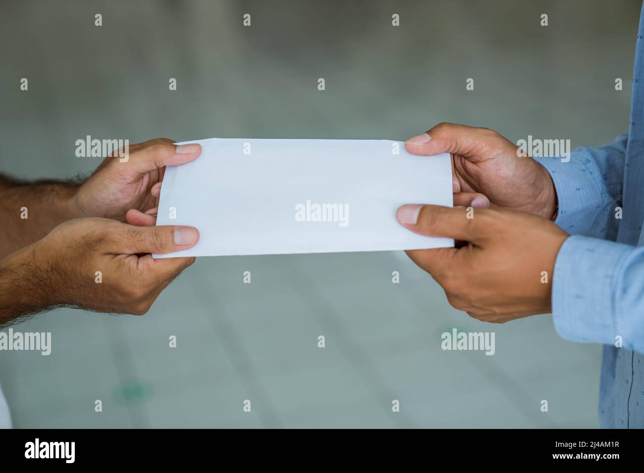 hand giving envelope as a charity donation at the mosque during ramadan ...