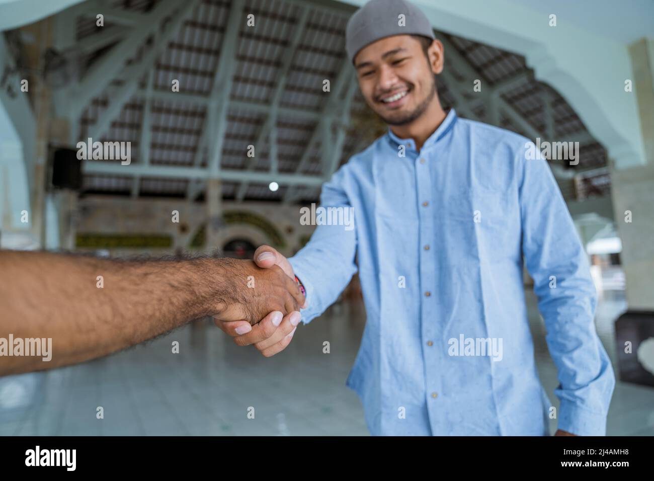 muslim people shaking hand at the mosque Stock Photo - Alamy