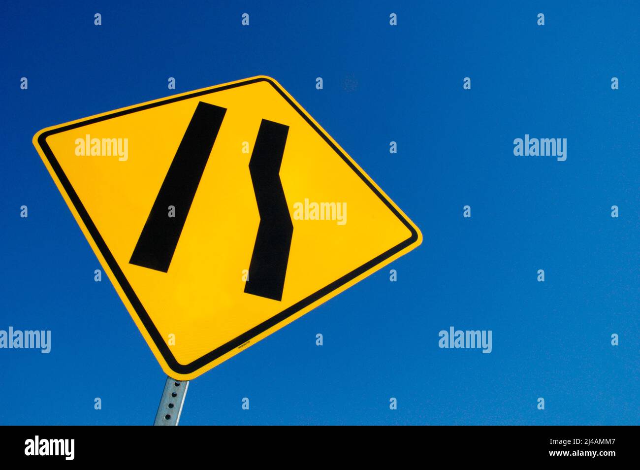 Freeway sign showing merge left as lane ends Stock Photo - Alamy