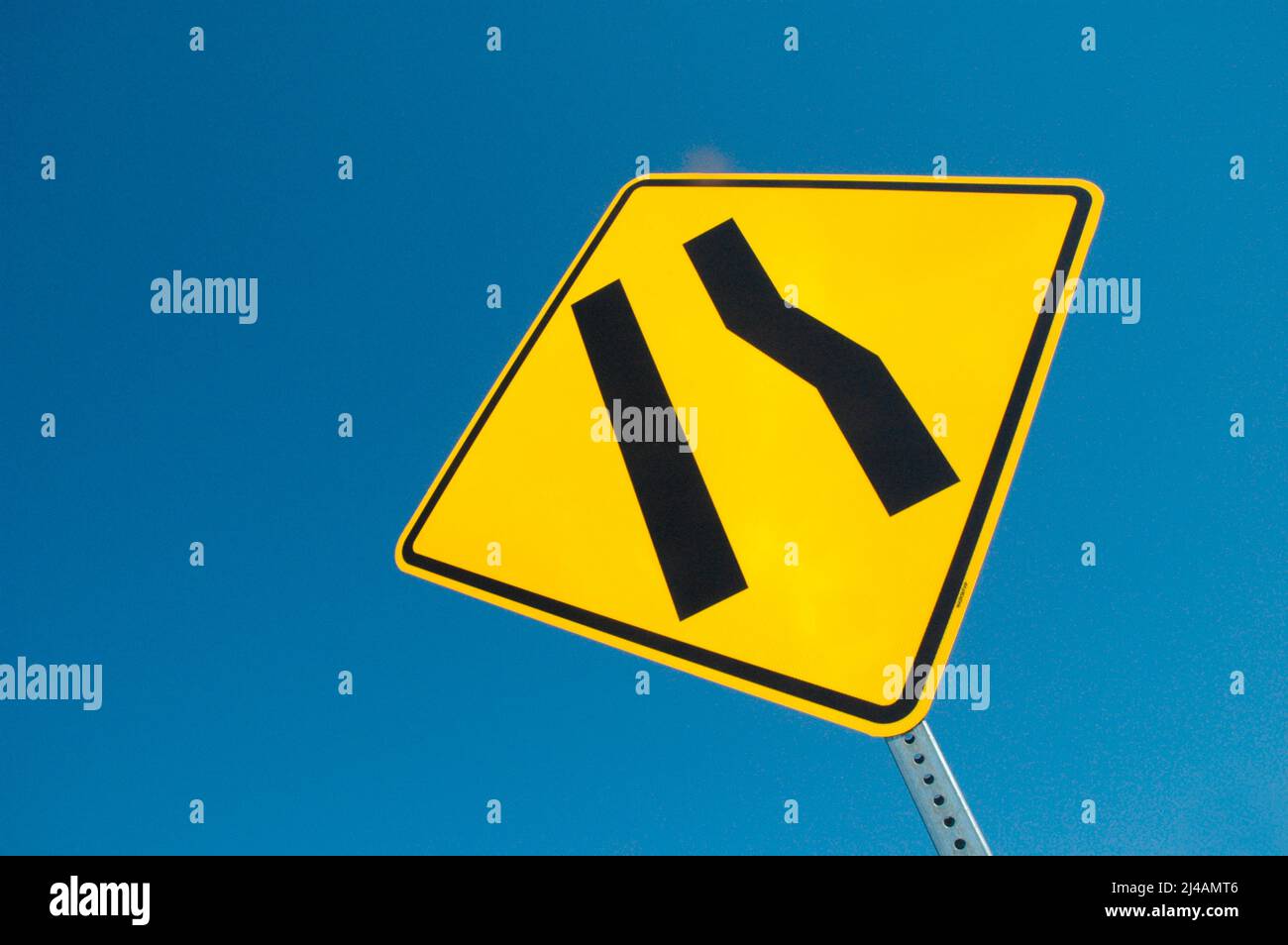 Freeway sign showing merge left as lane ends Stock Photo - Alamy