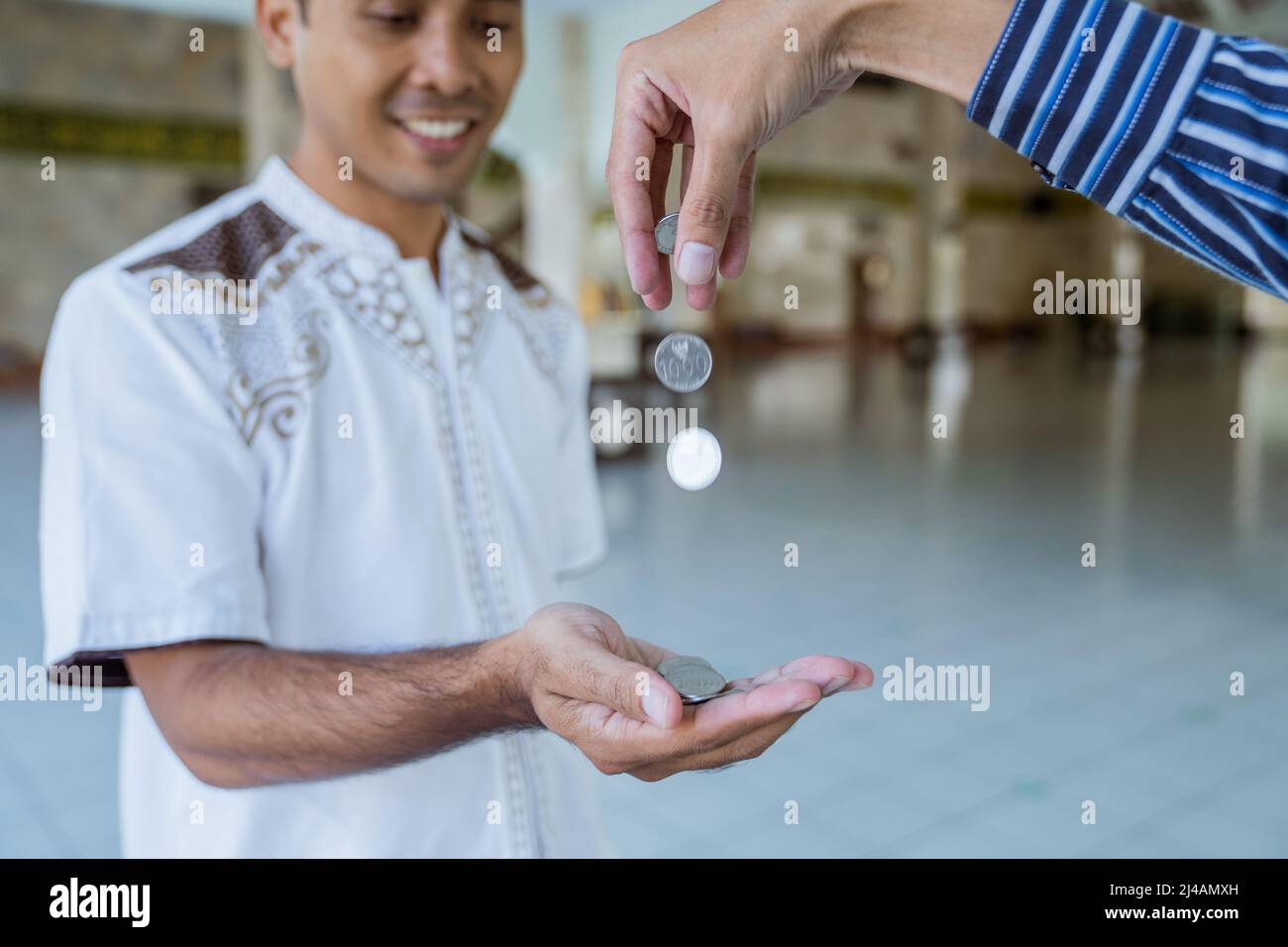 muslim paying some zakat charity using cash at the mosque Stock Photo ...