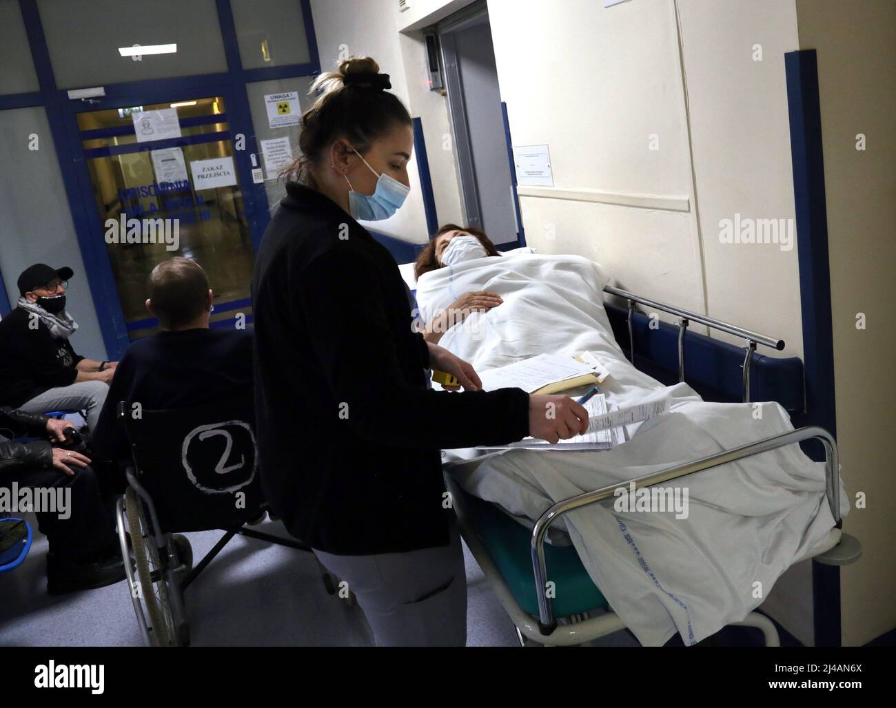 Cracow. Krakow. Poland. ER room worker examining medical records of a ...