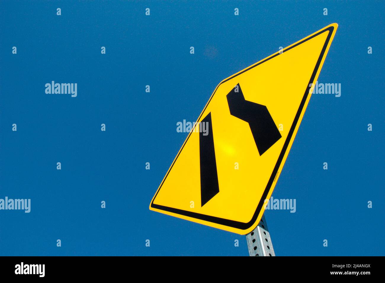 Freeway sign showing merge left as lane ends Stock Photo - Alamy