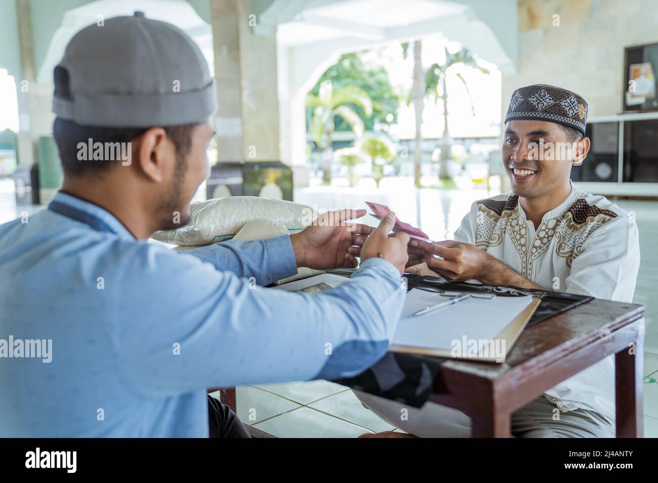 muslim paying some zakat charity using cash at the mosque Stock Photo ...