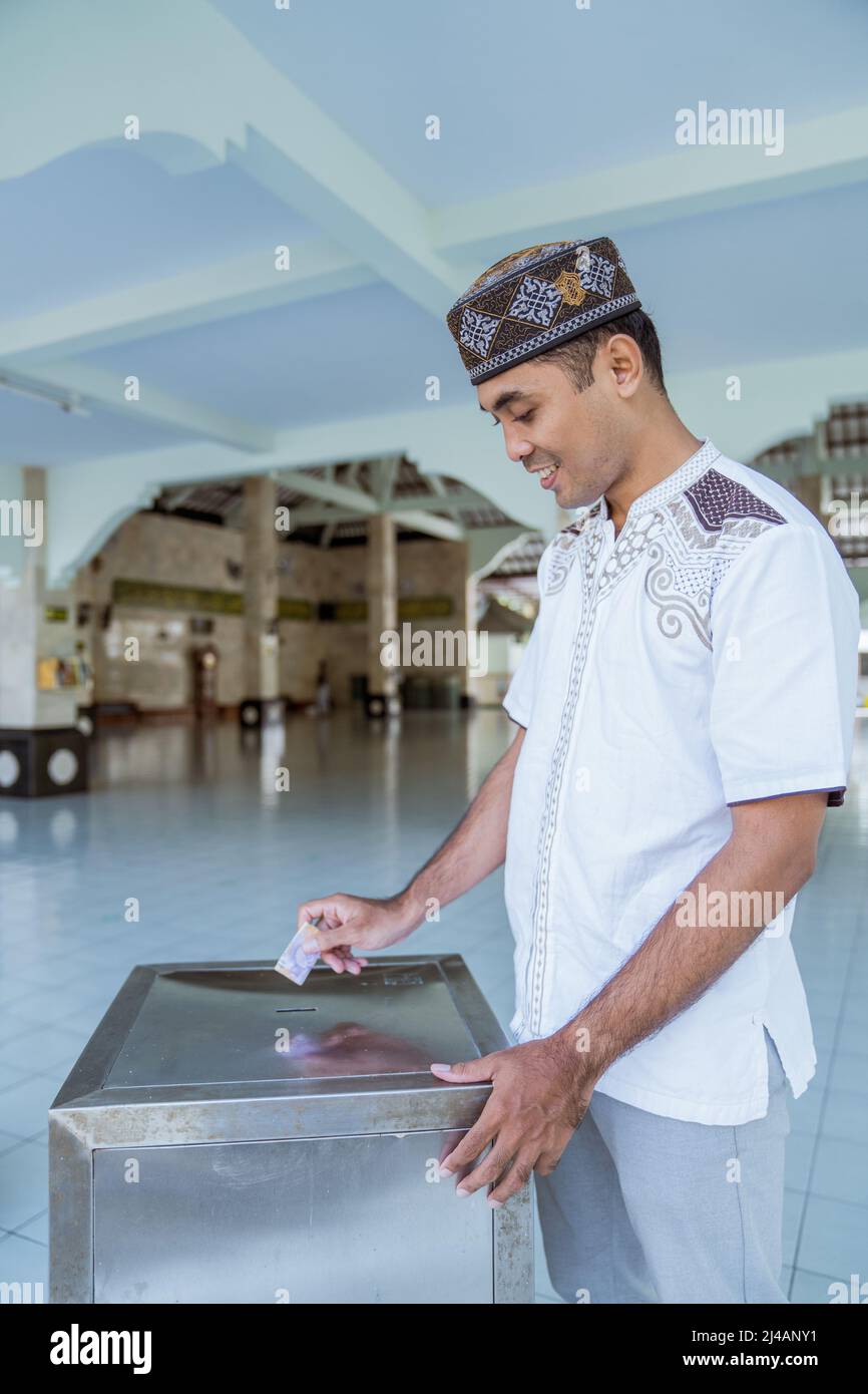 muslim paying some zakat charity using cash at the mosque Stock Photo ...