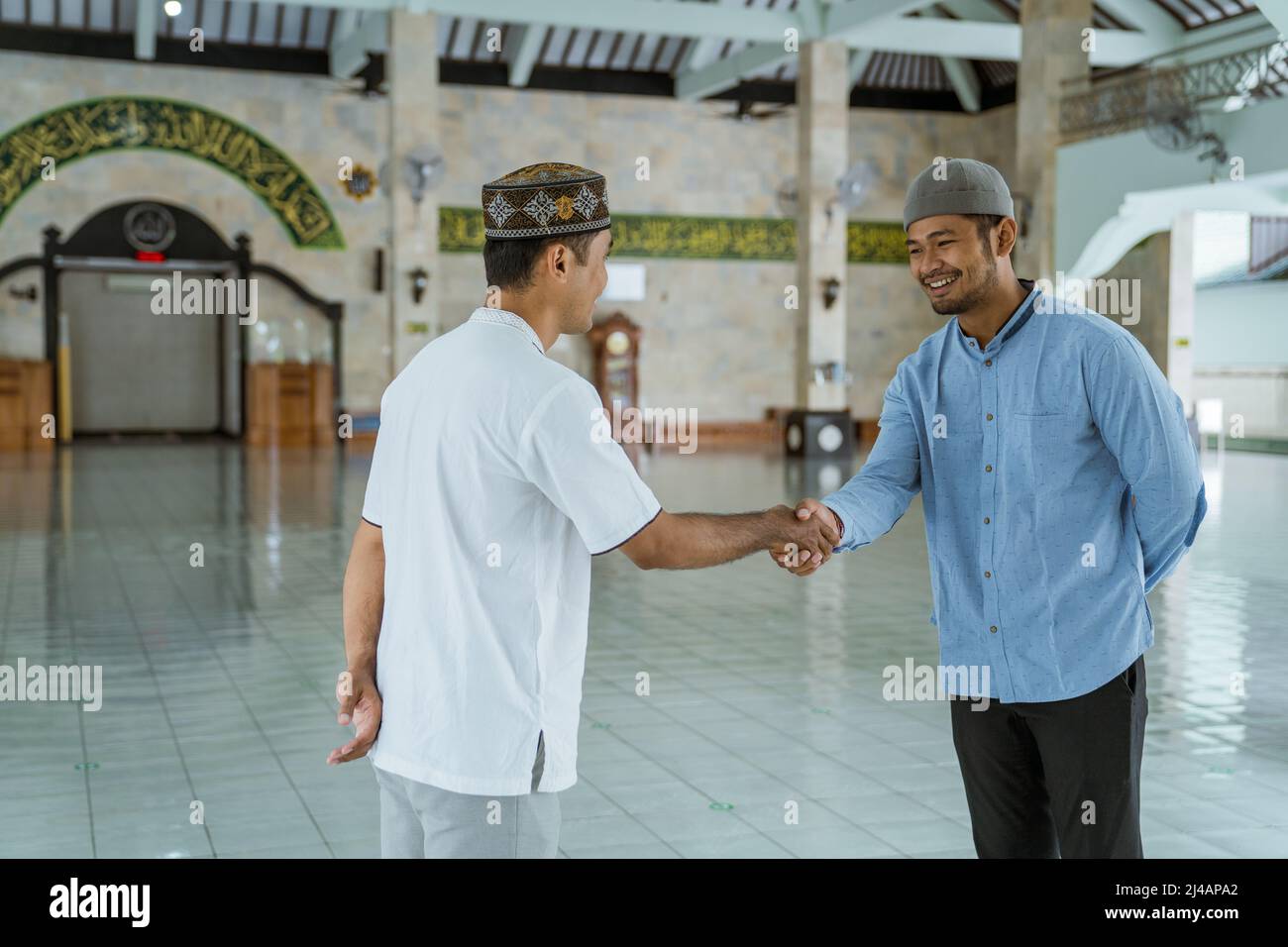 muslim people shaking hand at the mosque Stock Photo - Alamy