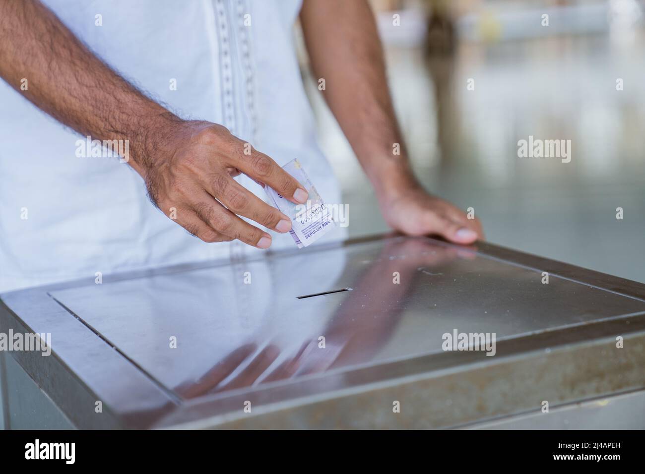 hand put some money in to the charity box in the mosque Stock Photo - Alamy