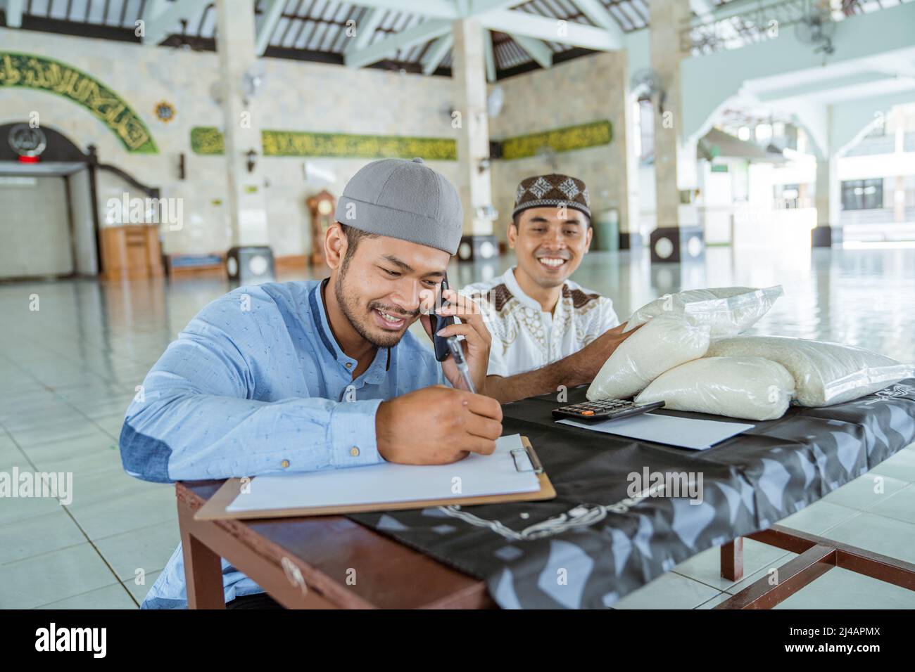 mosque worker counting on the charity they get during ramadan Stock ...