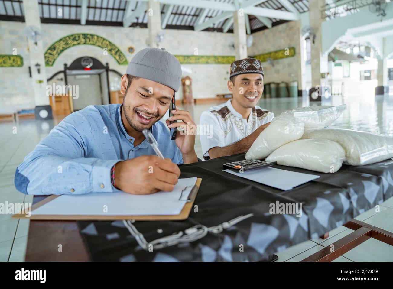 mosque worker counting on the charity they get during ramadan Stock ...