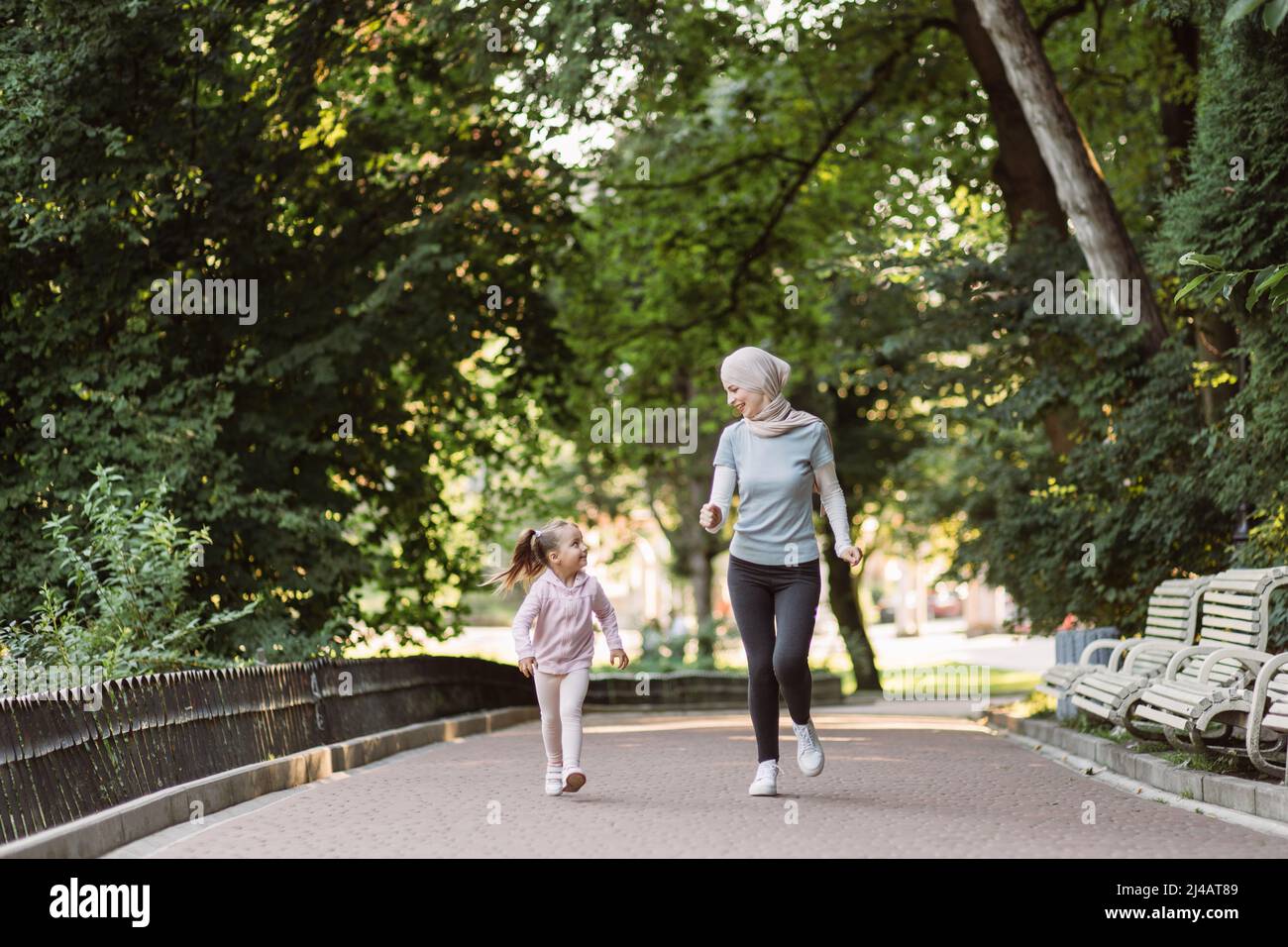 Family sports and outdoor activity concept. Cheerful young Muslim ...