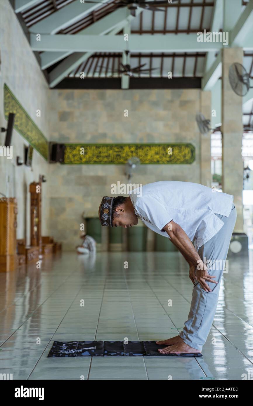 muslim male bowing during praying at the mosque Stock Photo - Alamy