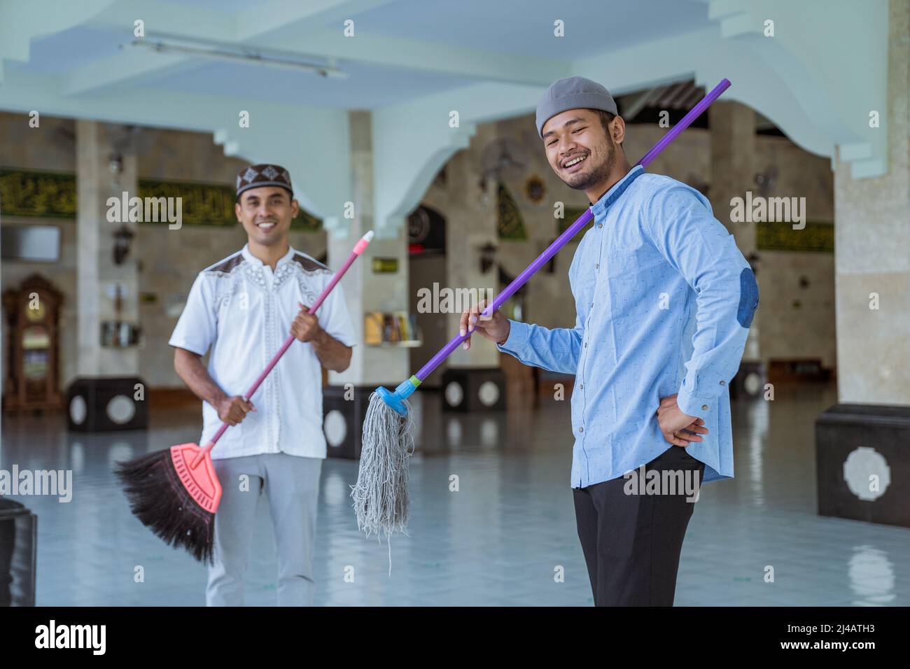 muslim male cleaning the mosque using broom and sweeping the floor ...