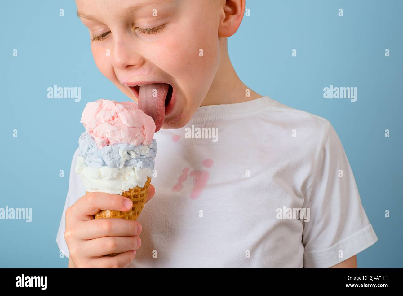 The boy licking ice cream closed his eyes. dirty stain of ice cream on ...