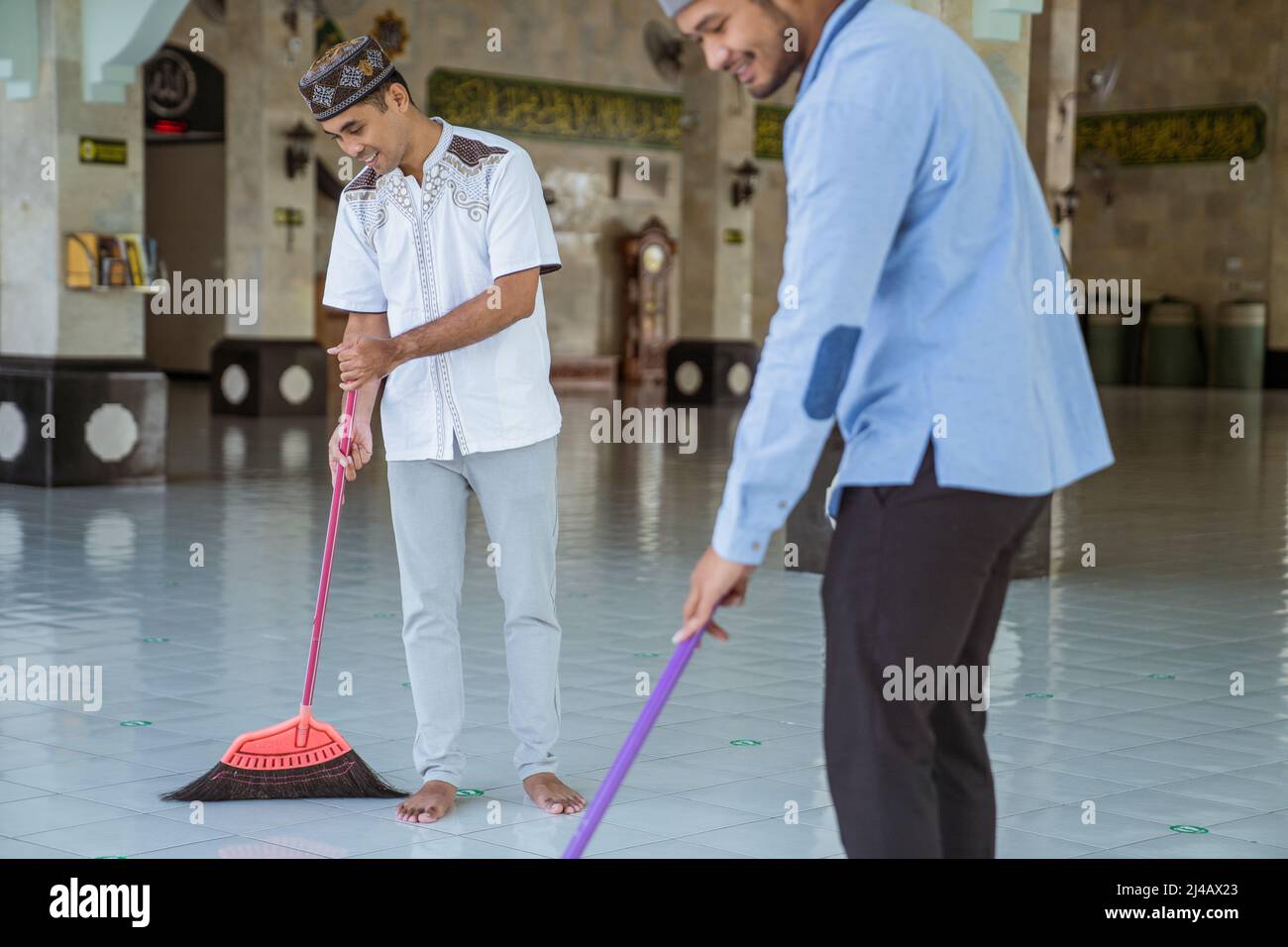 muslim male cleaning the mosque using broom and sweeping the floor ...