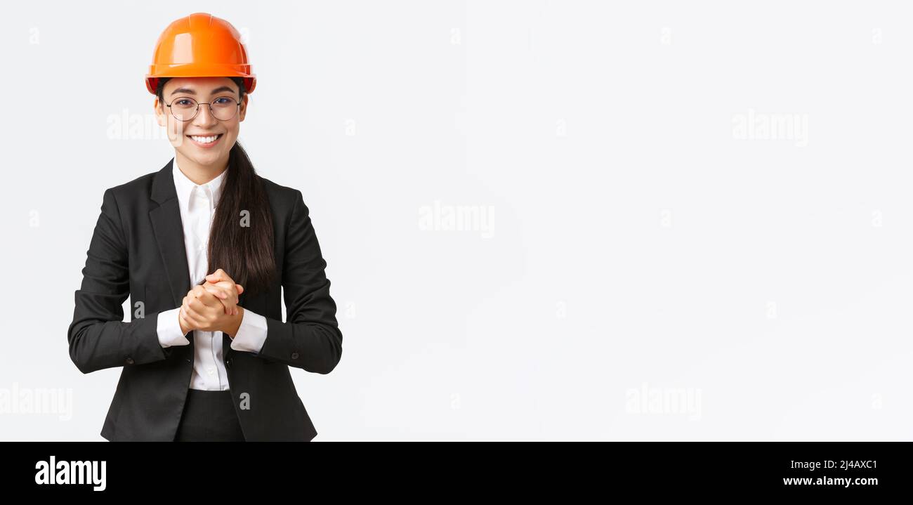 Smiling professional asian businesswoman in safety helmet and business ...