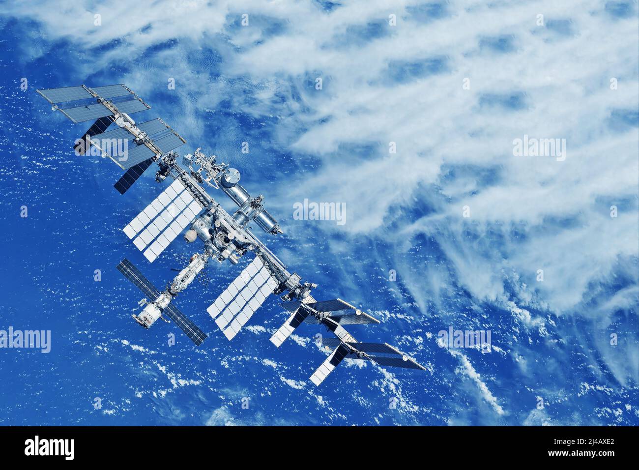 ISS over the planet, against the background of clouds. Elements of this ...