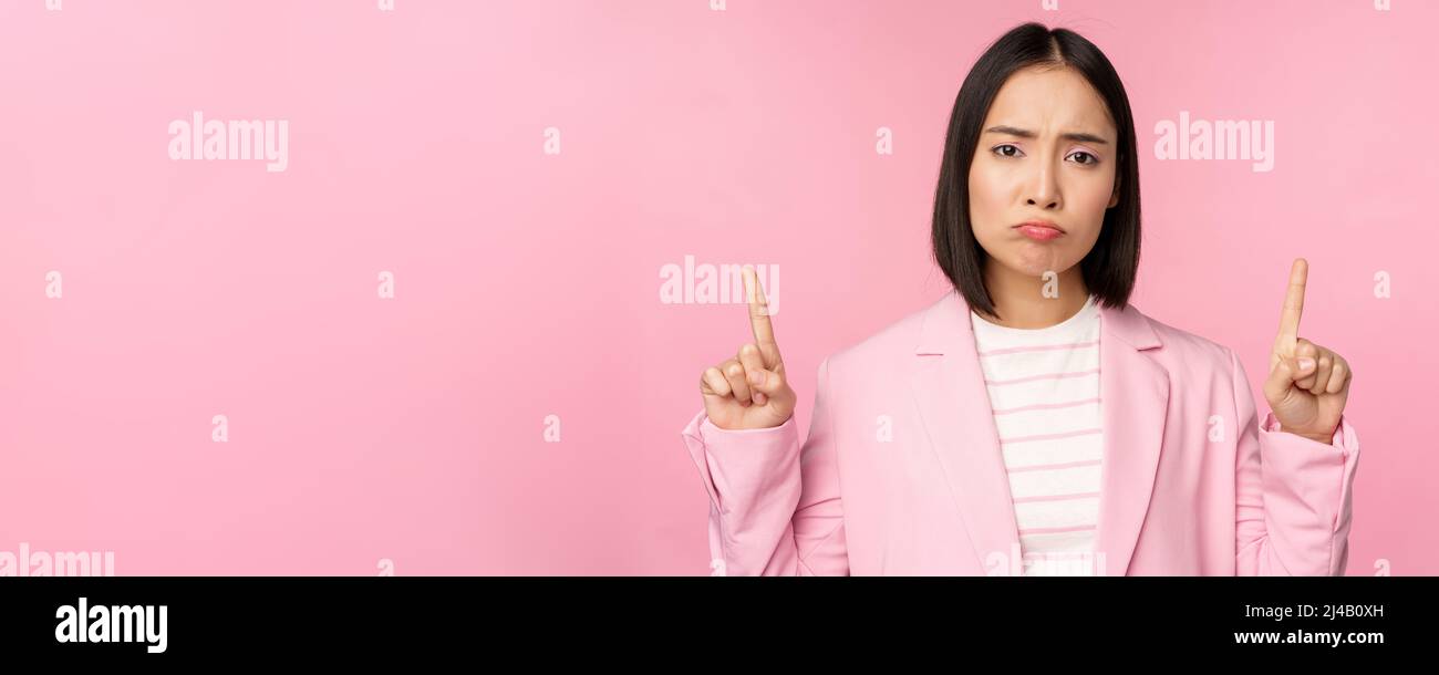 Sad asian business woman, professional corporate manager pointing ...