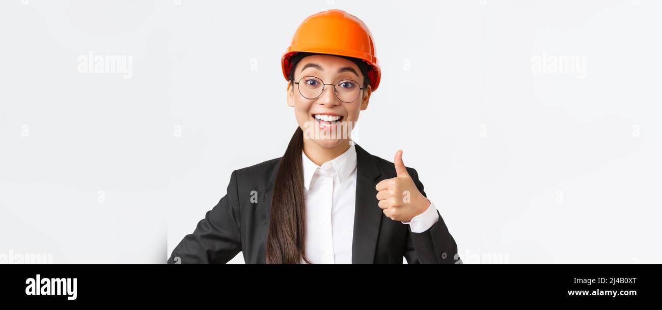 Close-up of professional pleased asian female chief engineer, architect ...