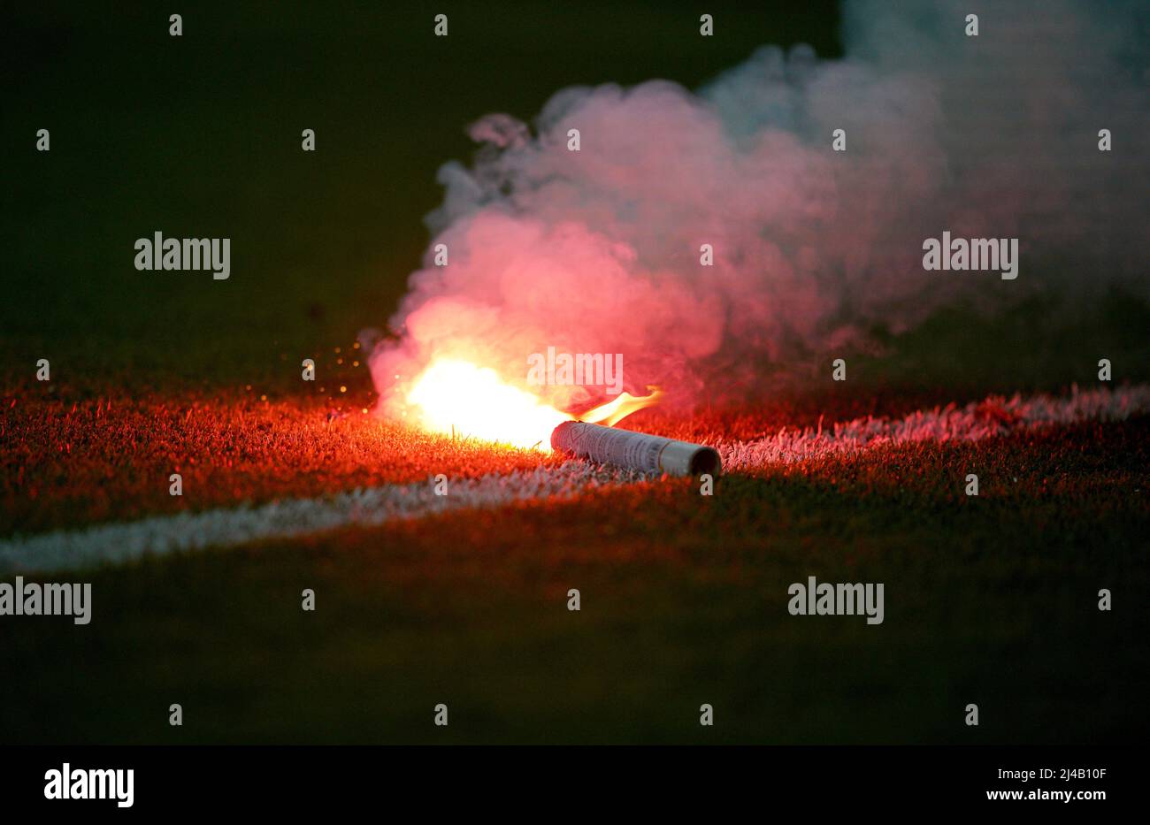 A flare thrown by a Benfica fan onto the pitch during the UEFA ...