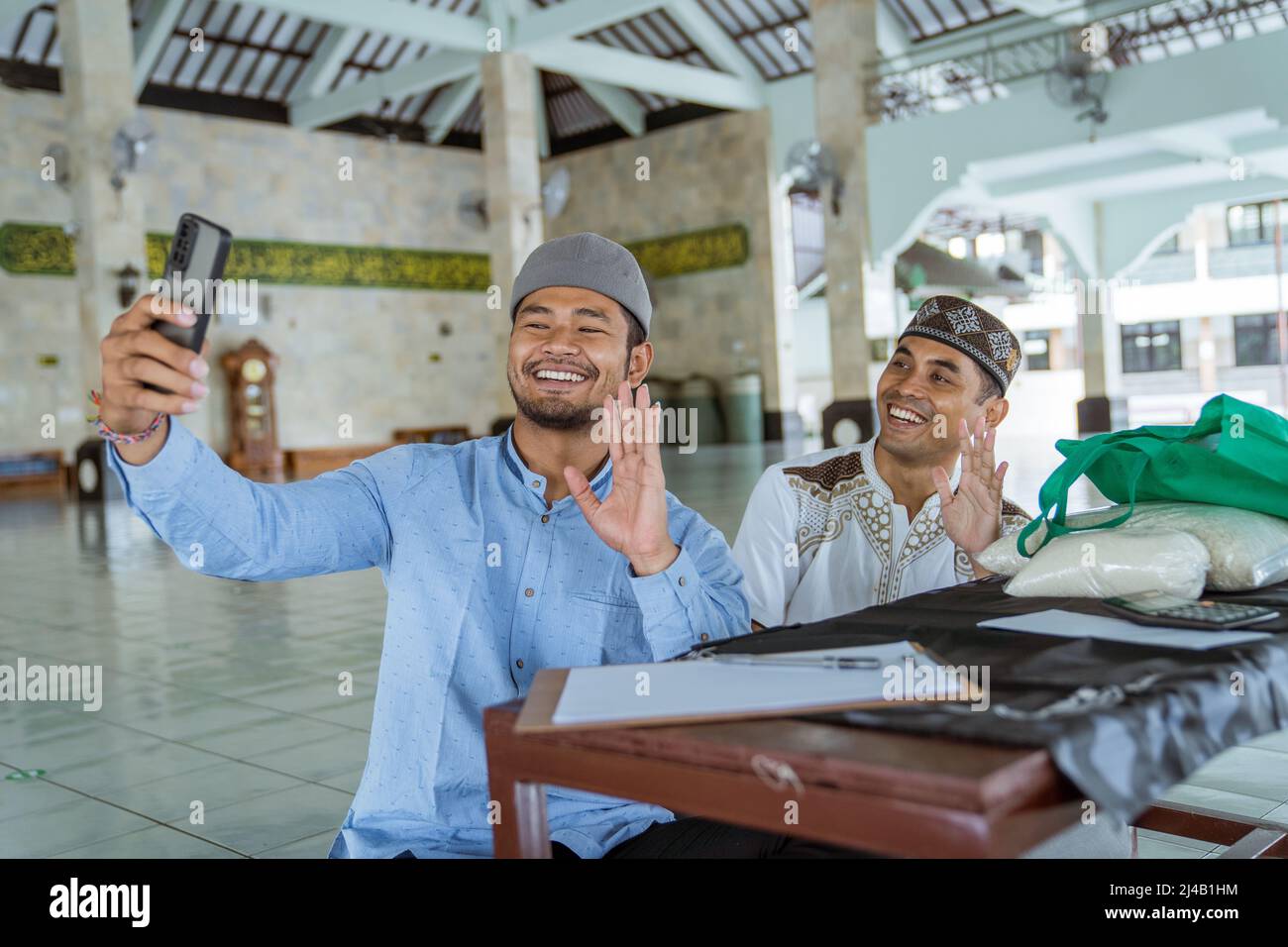 muslim man giving a rice as a food donation for zakat during eid ...