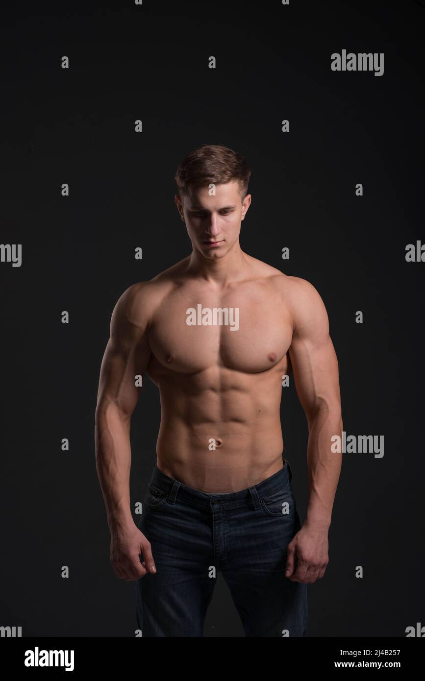 man with a sporty physique in the studio on a black background Stock ...