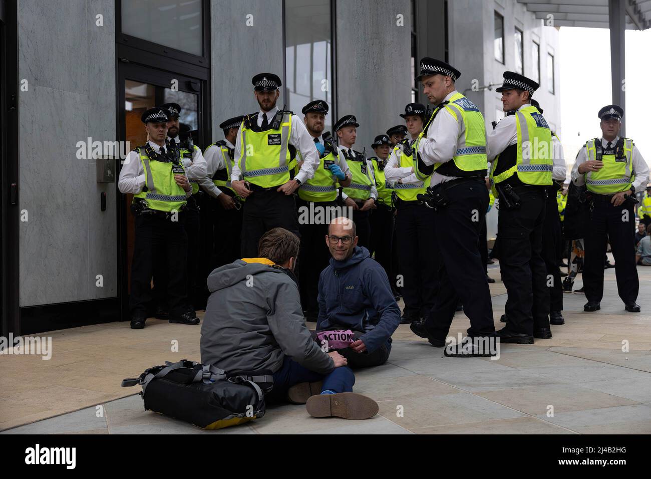 London, UK. 13th Apr, 2022. A protester with his hand glued on the ...