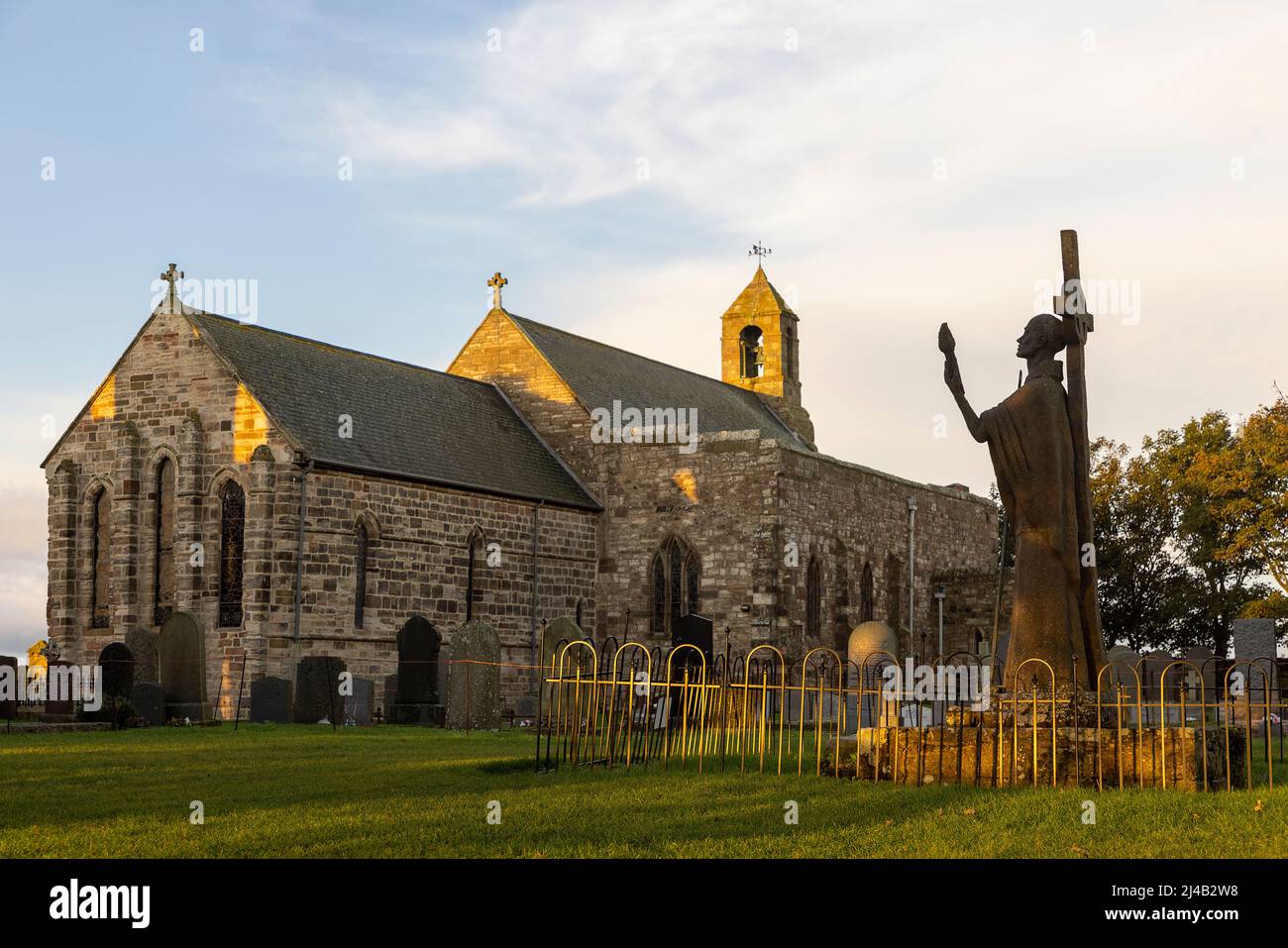 Parish Church of St Mary the Virgin on Holy Island with the statue of ...