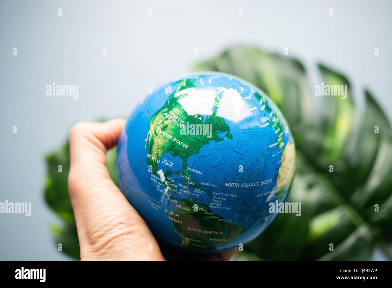 hand holding globe environment esg concept Stock Photo - Alamy