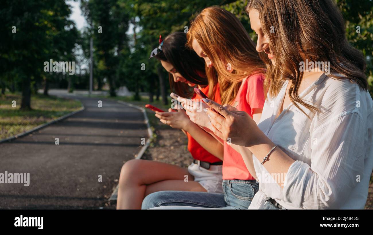 Cell Phone Addiction. Group of young multi-ethnic girls using ...
