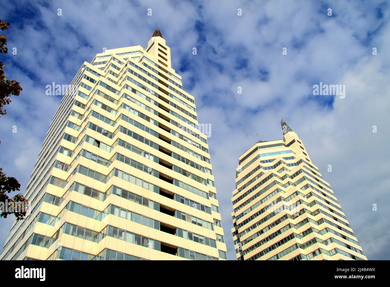 Tall white buildings, towers, skyscrapers against background of clouds ...