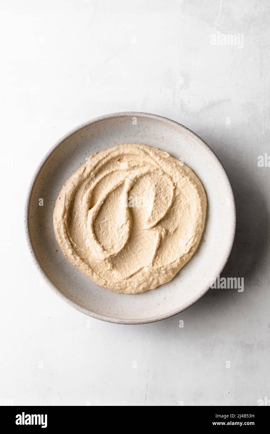 Hummus in a ceramic bowl Stock Photo - Alamy