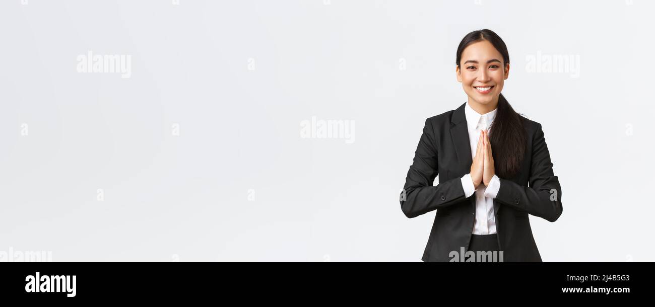 Hopeful glad asian businesswoman in black suit bowing politely and say ...